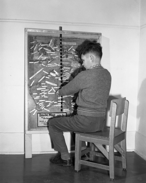 Blind & Deaf Institute, visually-impaired boy reading a Braille map ...